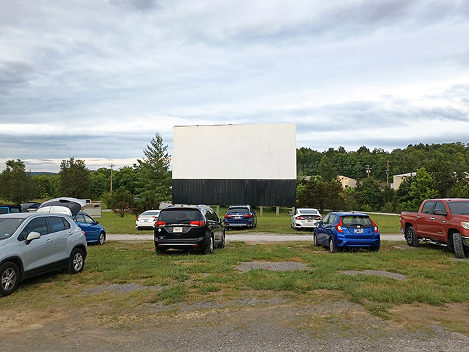 The classic white screen against the Tennessee sky stands ready for dusk, when movie magic transforms this humble field into a communal theater under the stars.