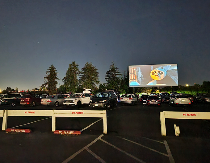 Movie magic comes alive under the stars as cars gather before the giant screen. Nothing beats watching the latest blockbuster from your own four-wheeled theater seat.
