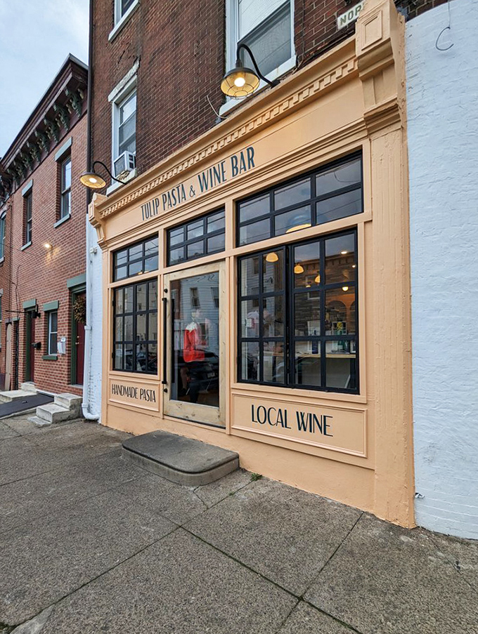 The peachy fa&ccedil;ade of Tulip Pasta & Wine Bar stands out like a culinary beacon among Philadelphia's brick buildings, promising handmade pasta treasures within.