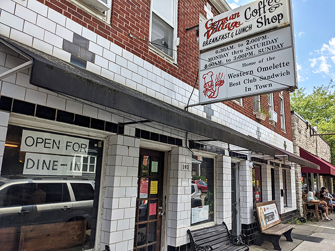 The iconic white-tiled exterior of German Village Coffee Shop stands as a beacon of breakfast hope in Columbus's historic neighborhood.