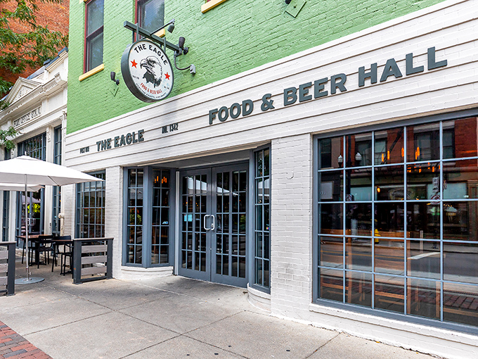 The mint-green facade of The Eagle OTR stands out like a culinary beacon on Vine Street, promising Southern comfort with urban flair.