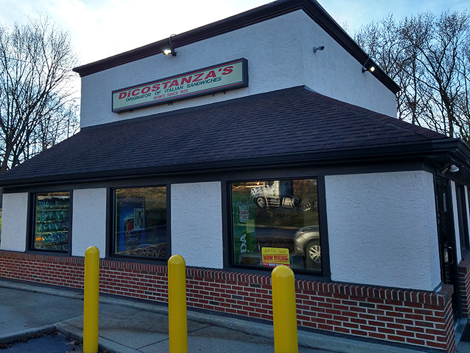 The unassuming white building with its bright yellow bollards stands like a sandwich sentinel, guarding hoagie perfection within its humble walls.