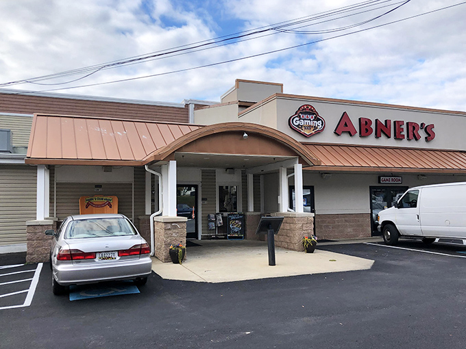 Abner's welcoming facade promises seafood treasures within. The copper-toned roof and stone accents say "Maryland crab house" before you even step inside.