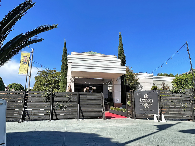 Another view of Lawry's classic exterior, where the black fence and red carpet create the perfect prelude to the culinary theater waiting inside.