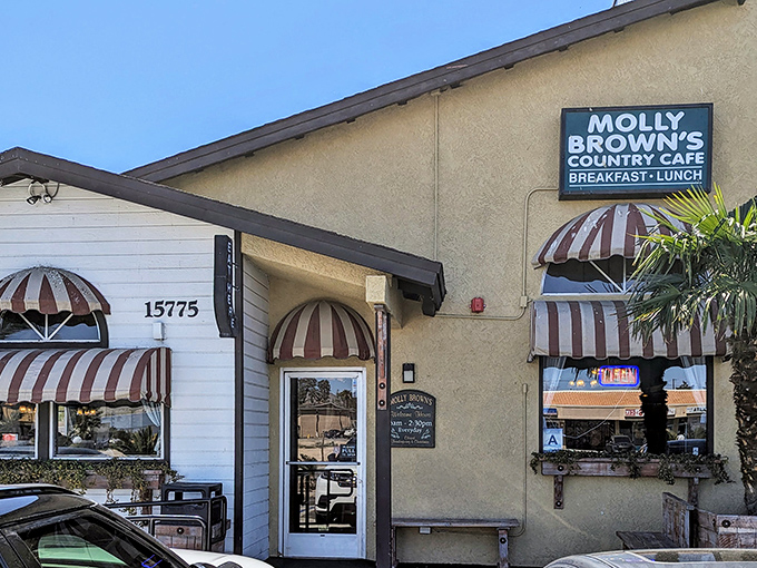 The unassuming exterior of Molly Brown's Country Cafe, with its charming striped awnings, promises comfort food treasures within. Desert dining at its finest!