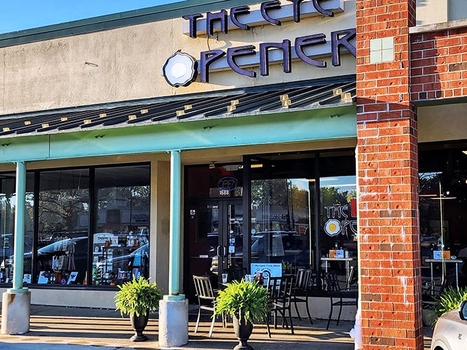 The welcoming storefront of The Eye Opener beckons with its distinctive sign and cozy patio seating&mdash;breakfast paradise awaits behind those doors.