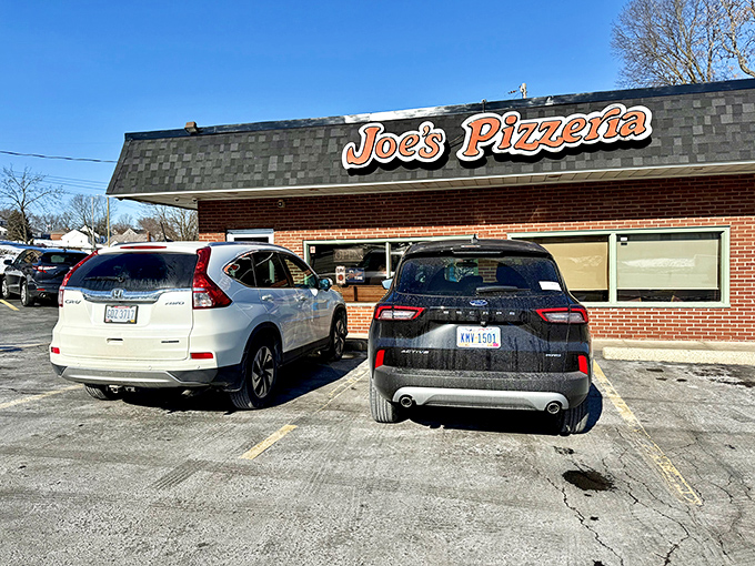 That classic orange sign against the brick fa&ccedil;ade isn't trying to impress anyone&mdash;it's too busy announcing where serious pizza lovers need to be.
