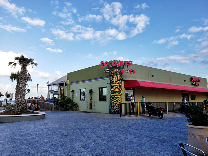 The turquoise beacon of beachside bliss! Coconuts on the Beach announces itself with tiki flair and a color scheme that screams "vacation mode activated."