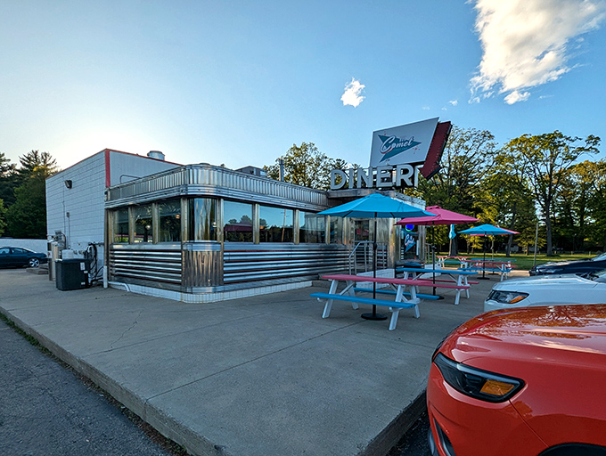 Classic Americana gleams in the Michigan sunshine. The Comet's stainless steel exterior and colorful picnic tables promise a time-traveling culinary adventure.