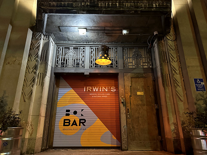 The entrance to culinary paradise isn't always pearly gates &ndash; sometimes it's a colorful rolling door in an Art Deco building that whispers, "Sicilian treasures await upstairs."