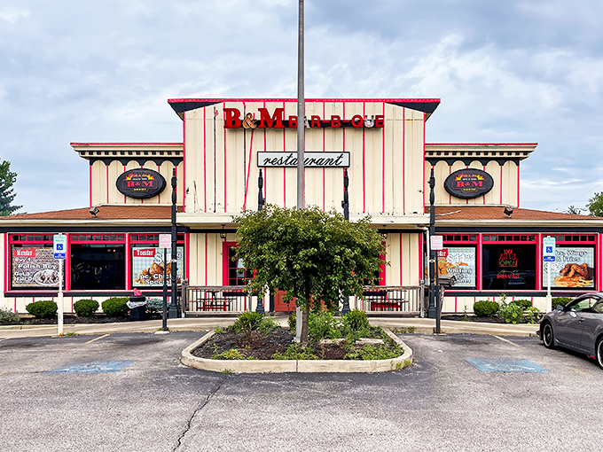 The cream and red-striped exterior of B & M Bar B Que stands like a barbecue lighthouse, beckoning hungry travelers with promises of smoky delights.