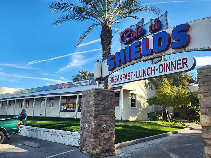 The iconic Shields Date Garden welcomes visitors with its vintage charm and towering palm trees&mdash;a true desert oasis where culinary magic happens.