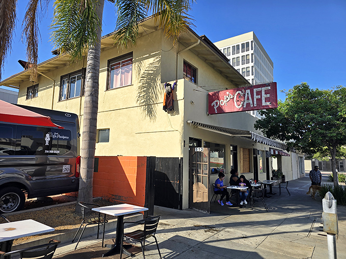 The unassuming yellow exterior of Pop's Cafe stands as a beacon of breakfast hope in Santa Ana, where California sunshine meets classic American diner charm.