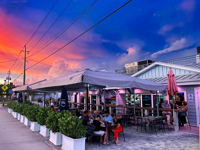 The pastel-pink exterior of Lock 'N Key glows like a Florida sunset, complete with colorful umbrellas that practically whisper "come sit a while" to passersby.