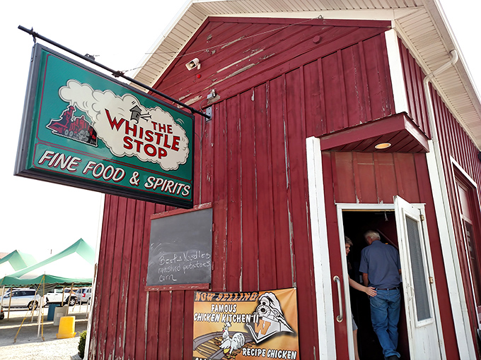 The iconic red barn exterior of The Whistle Stop beckons hungry travelers like a culinary lighthouse in Ansonia's sea of cornfields.