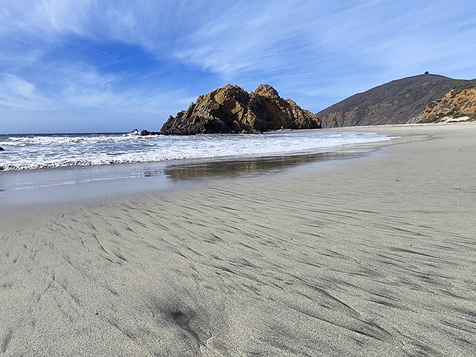 Nature's perfect postcard moment: dramatic cliffs embrace a pristine shoreline where the Santa Lucia Mountains meet the restless Pacific in spectacular harmony.