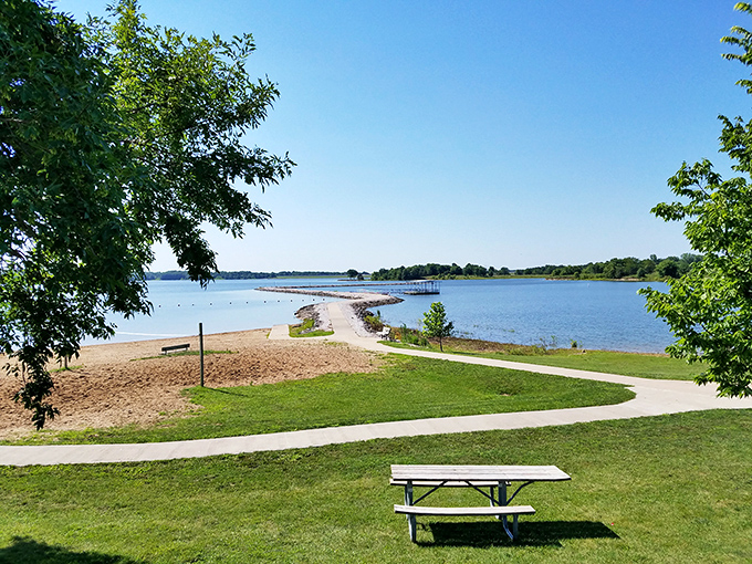 Mother Nature's own infinity pool. The gentle curve of sandy shoreline meets crystal-clear waters under Missouri's big sky, creating a postcard moment.