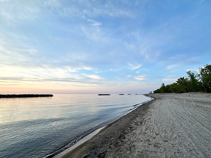 The gentle curve of Presque Isle's shoreline stretches toward the horizon, where water meets sky in a perfect Pennsylvania postcard moment.
