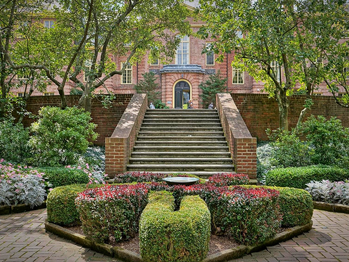 Grand brick steps lead to Kingwood's mansion, where meticulously sculpted hedges stand like botanical sentries guarding a horticultural wonderland.
