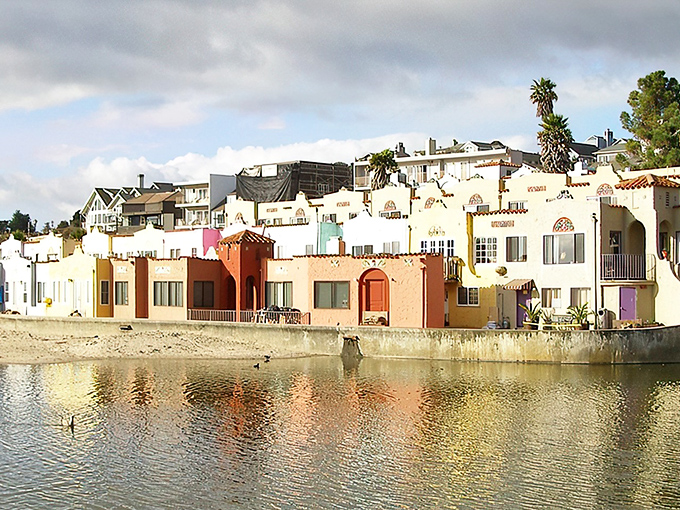 Capitola's iconic rainbow-hued Venetian Court buildings reflect in Soquel Creek like a Mediterranean daydream that somehow landed in California.