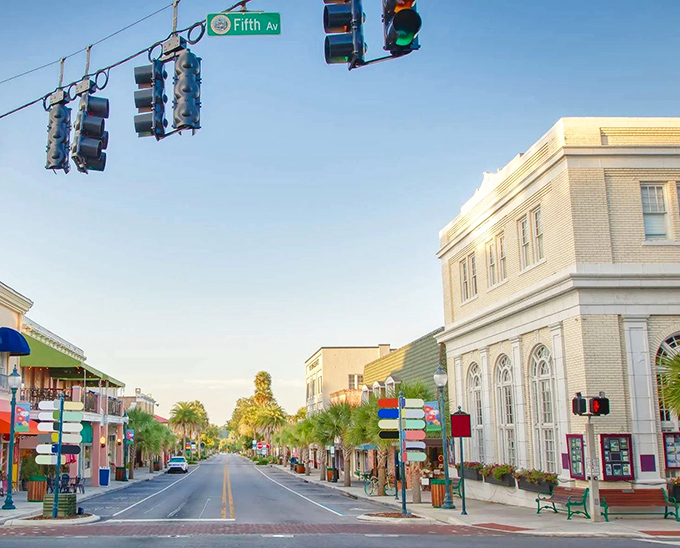 Downtown Mount Dora's Fifth Avenue welcomes visitors with palm-lined streets and colorful storefronts that feel worlds away from Florida's typical tourist destinations.