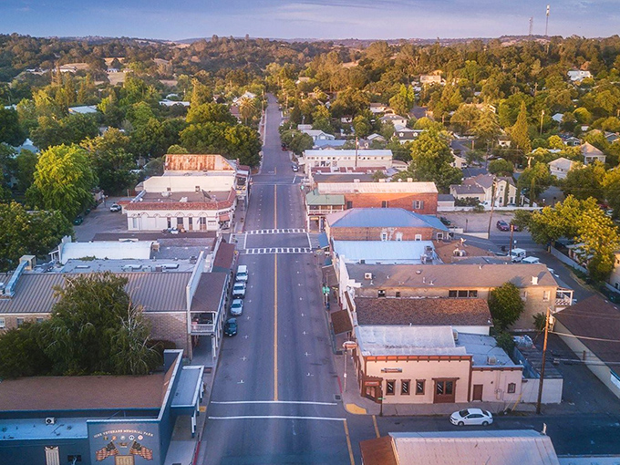 Aerial view of Ione's main street stretching through town like a ribbon of possibility, where traffic jams mean three cars at the stop sign.