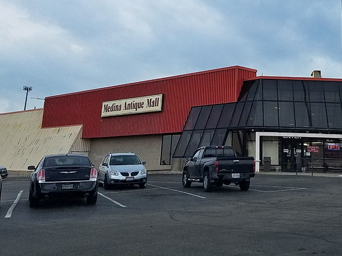 The bright red exterior of Medina Antique Mall stands like a beacon for treasure hunters. Inside awaits a labyrinth of memories and potential discoveries.
