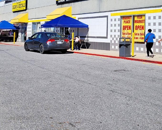 The bright yellow awnings of Washington Boulevard Marketplace beckon like a beacon of bargain possibilities, promising treasures waiting to be discovered inside.