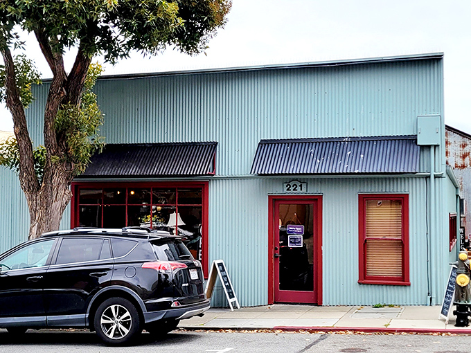 The mint-green building with cherry-red trim stands like a colorful beacon of bargains on Forest Avenue, promising treasures within its unassuming exterior.