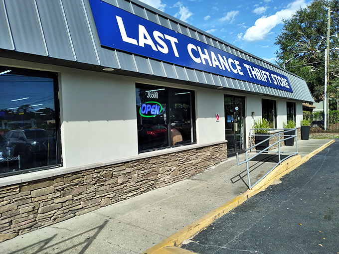 The iconic blue signage of Last Chance Thrift Store stands out against Florida's moody sky, promising treasure hunters a day of discoveries within.