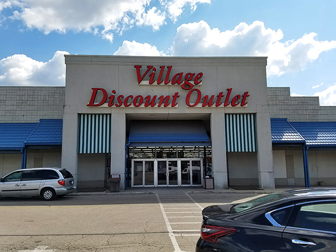 The iconic red signage of Village Discount Outlet stands out against the Dayton sky, a beacon for bargain hunters and treasure seekers alike.