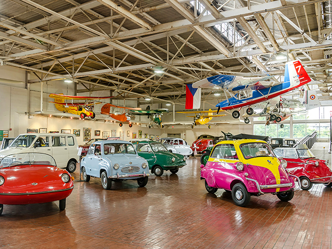 Golden automotive dreams float through this industrial cathedral where transportation history comes alive.