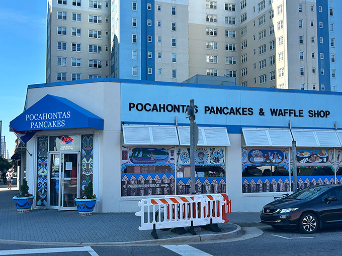 The iconic blue awning of Pocahontas Pancake House stands like a breakfast beacon on Virginia Beach's oceanfront, promising carb-laden bliss to hungry beachgoers.