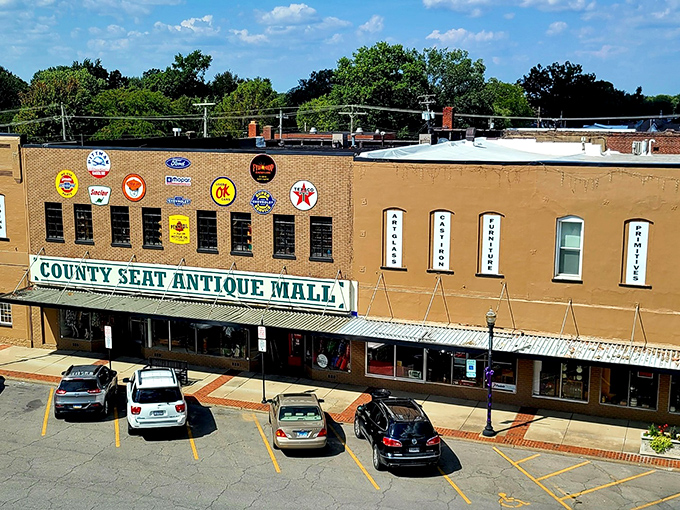 The brick facade of County Seat Antique Mall beckons treasure hunters with its vintage charm and promise of discoveries waiting just beyond those glass doors.