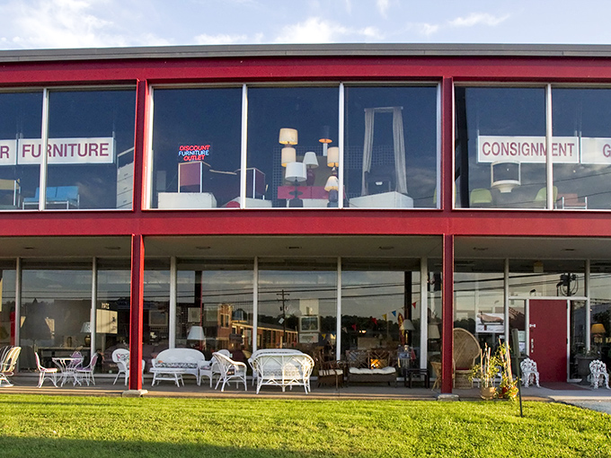 The distinctive red-trimmed exterior of Red Door Consignment Gallery stands out like a beacon for bargain hunters, promising treasures within those large display windows.