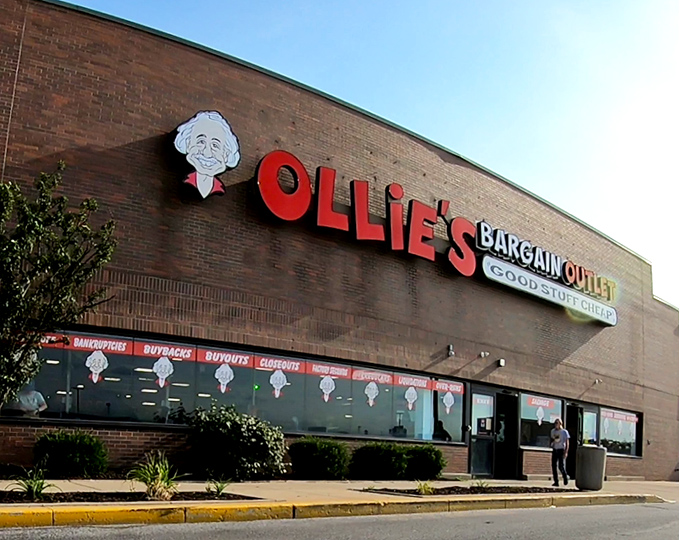 The iconic Ollie's storefront promises treasure hunting adventures with its bold red lettering and cartoon mascot beckoning bargain seekers inside.