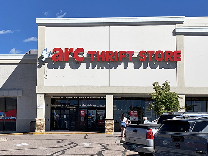 The iconic red signage of arc Thrift Store beckons bargain hunters like a retail lighthouse guiding ships to treasure-filled shores.