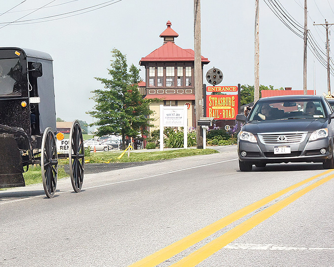 Where worlds collide: An Amish buggy shares the road with modern cars at the entrance to Strasburg Rail Road, a perfect metaphor for this time-traveling town.