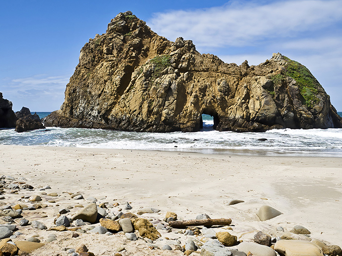 Keyhole Rock stands like a sentinel at Pfeiffer Beach, its natural arch carved by centuries of persistent waves and coastal winds.