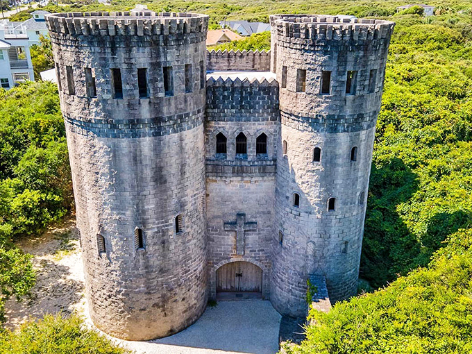 The imposing entrance, complete with twin towers and wooden door, looks ready to welcome knights returning from quests rather than tourists in flip-flops.