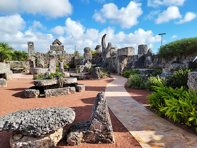 Stone pathways wind through this otherworldly garden where coral formations stand like ancient sentinels guarding secrets of impossible engineering.