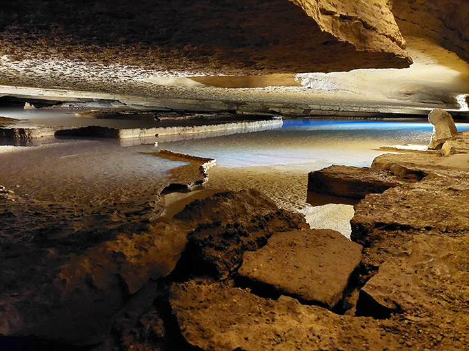 Nature's own infinity pool? The crystal-clear waters inside Bluff Dwellers Cave create mirror-like reflections that double the visual magic of this underground wonderland.