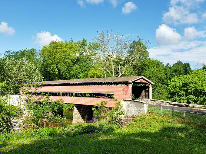 The rustic red exterior of Smith's Bridge stands proudly against Delaware's lush greenery, like a postcard from America's simpler past.