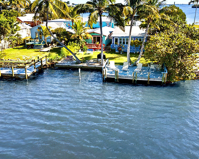 Waterfront living doesn't get more idyllic than this &ndash; colorful cottages nestled among swaying palms with private docks just steps from your door.