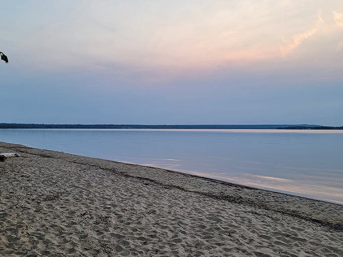 Twilight transforms Brimley's beach into nature's meditation studio, where water meets sky in perfect stillness.