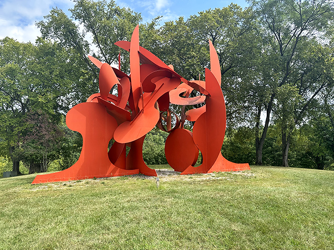 This fiery orange sculpture commands attention like a celebrity chef at a food festival, its curves and angles dancing against the Ohio sky.