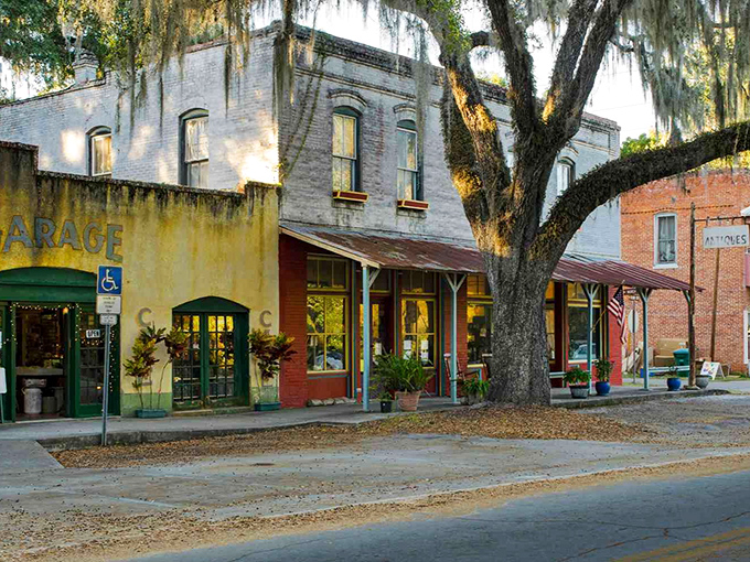 Cholokka Boulevard's historic storefronts stand frozen in time, where Spanish moss-draped oaks provide natural awnings over brick and mortar memories. 