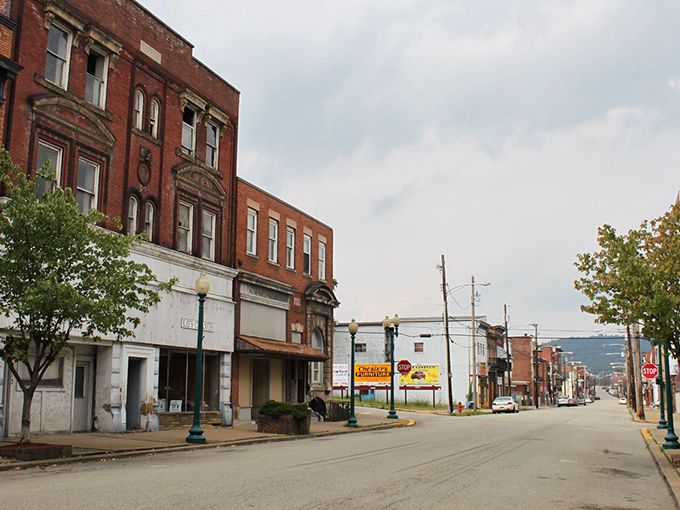 Donora's main street stretches toward green hills like a timeline connecting past and present, brick buildings standing sentinel to small-town stories.