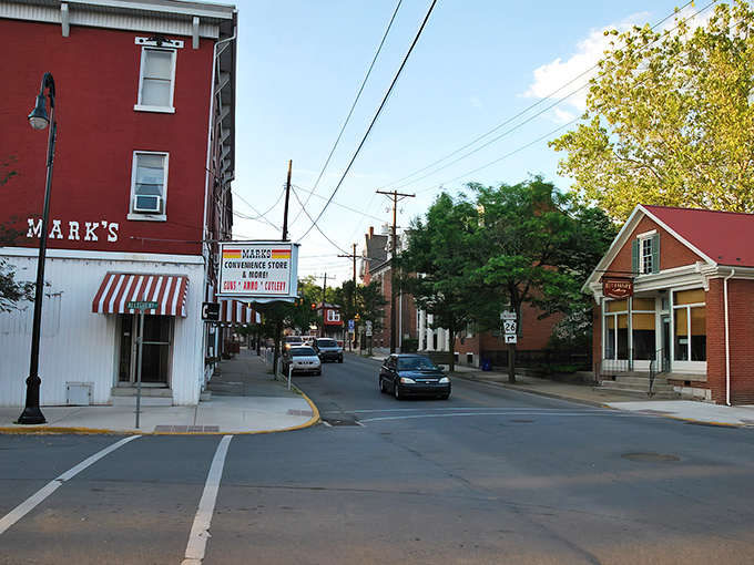 Mark's Convenience Store anchors this classic small-town streetscape, where brick buildings and striped awnings create that perfect "honey, I think we've found our retirement town" vibe.