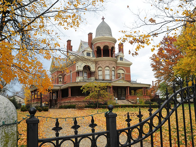 The Seiberling Mansion in autumn glory looks like it's auditioning for a Wes Anderson film&mdash;Victorian splendor framed by golden leaves and wrought iron elegance.